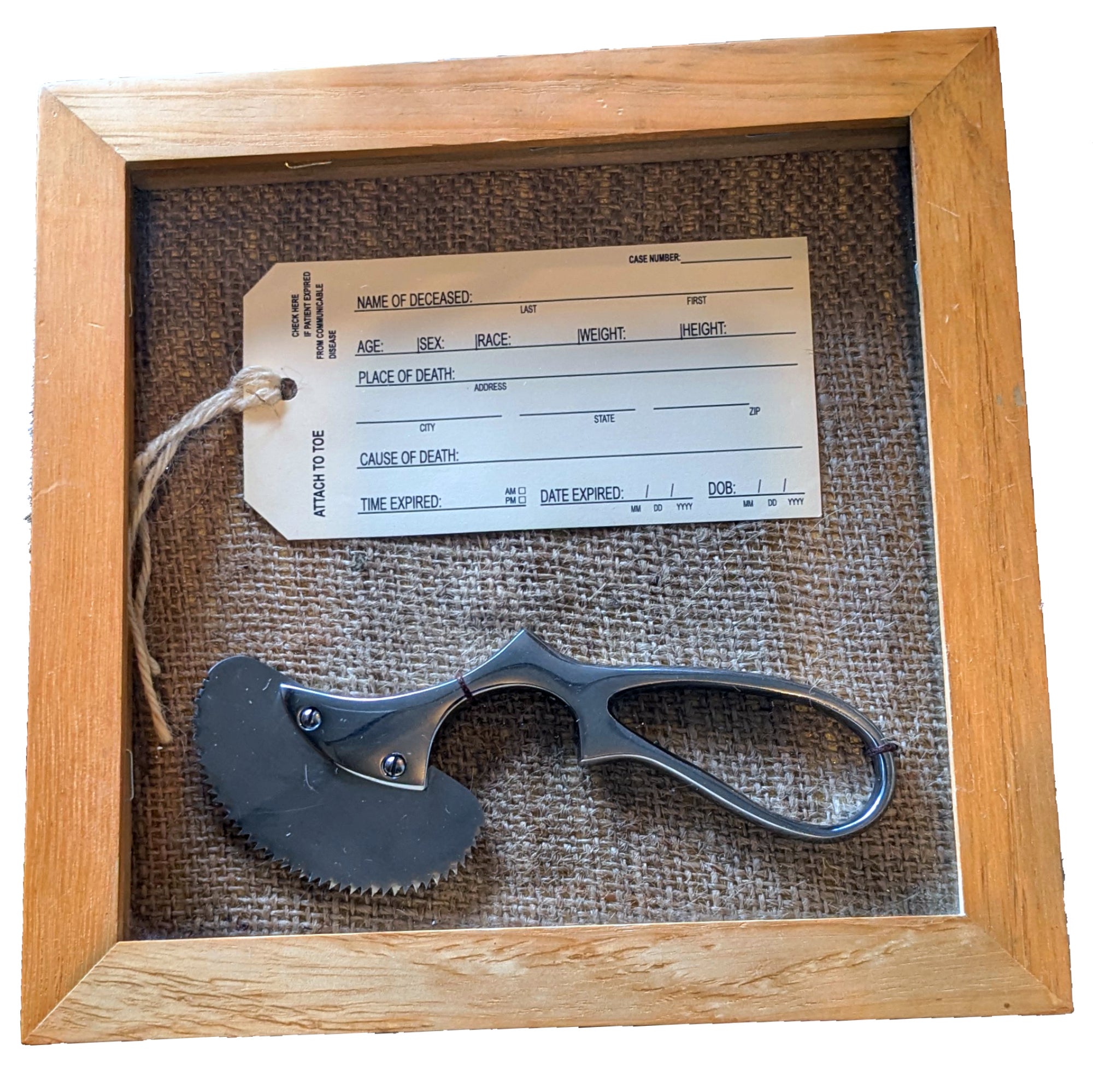 Framed bone saw & toe tag | Morbitorium